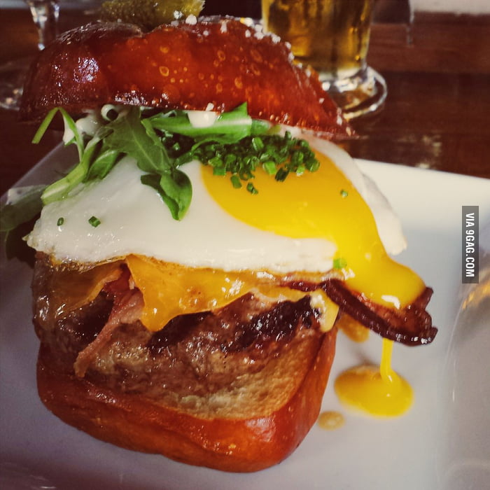 Burger with a runny egg waterfall over cliffs of bacon - 9GAG