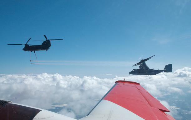 A V-22 Osprey flying behind the Helicopter Icing Spray System, or HISS ...