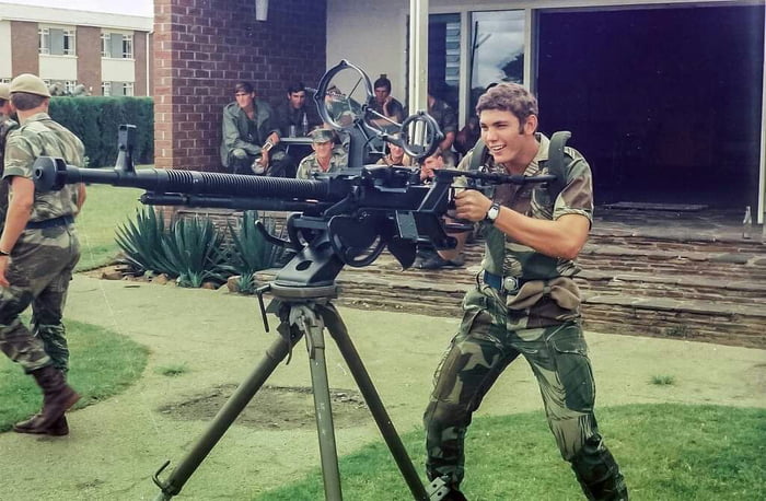 Rhodesian SAS trooper posing with a captured DShK machine gun, 1970's ...