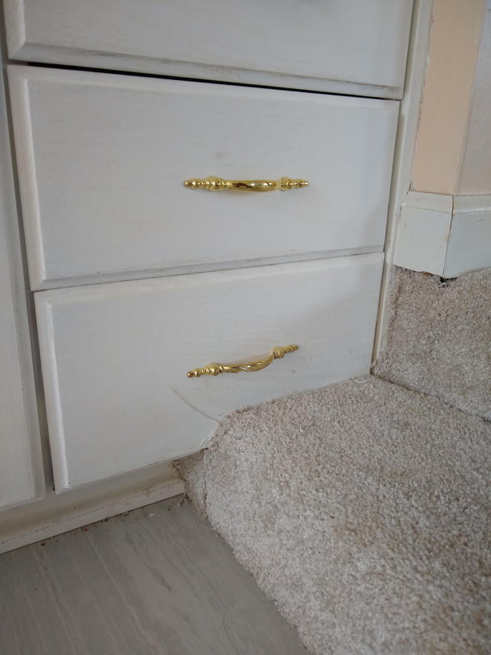 This remodeled bathroom with a carpeted step blocking a vanity drawer ...