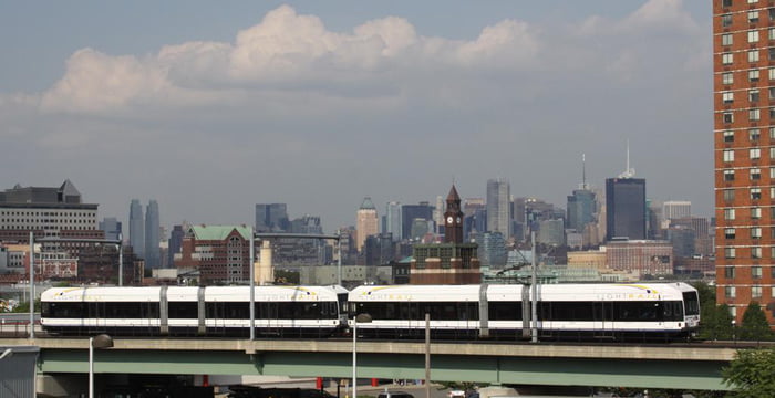 A 2-car Hudson-Bergen Light Rail train on an elevated viaduct in Jersey ...