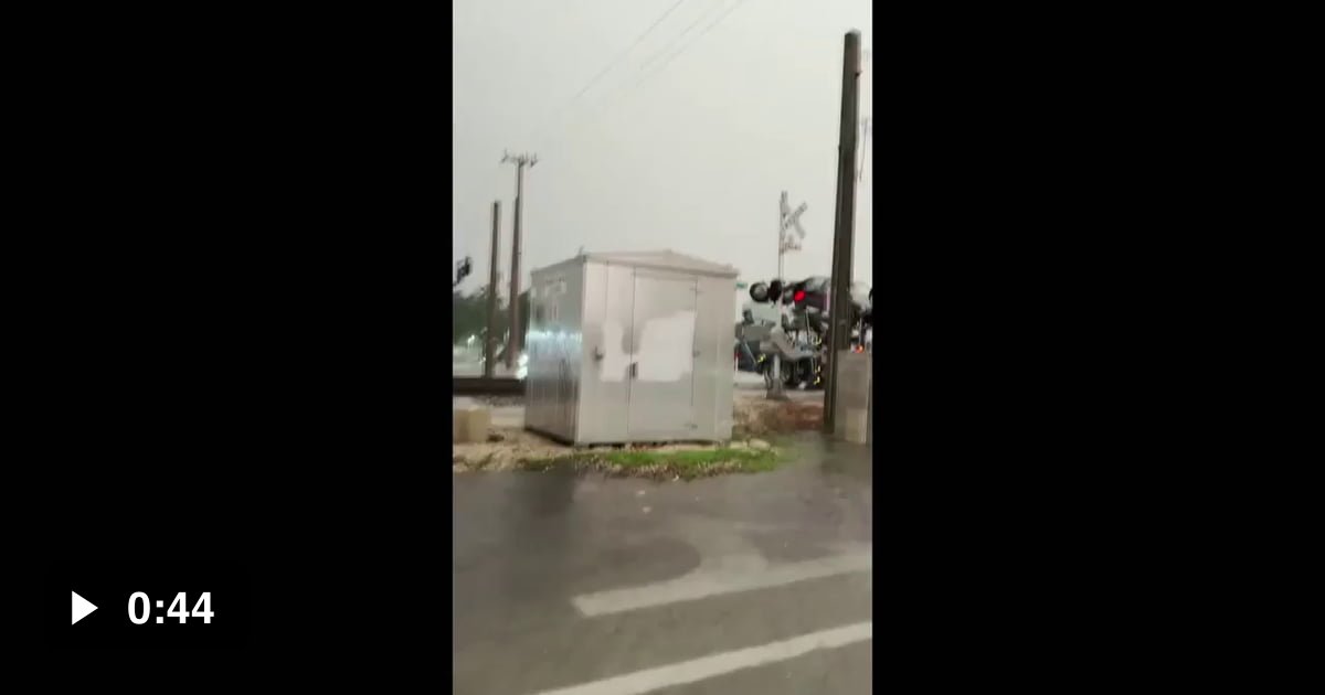 Commuter train smash through car hauler loaded with luxury vehicles in ...