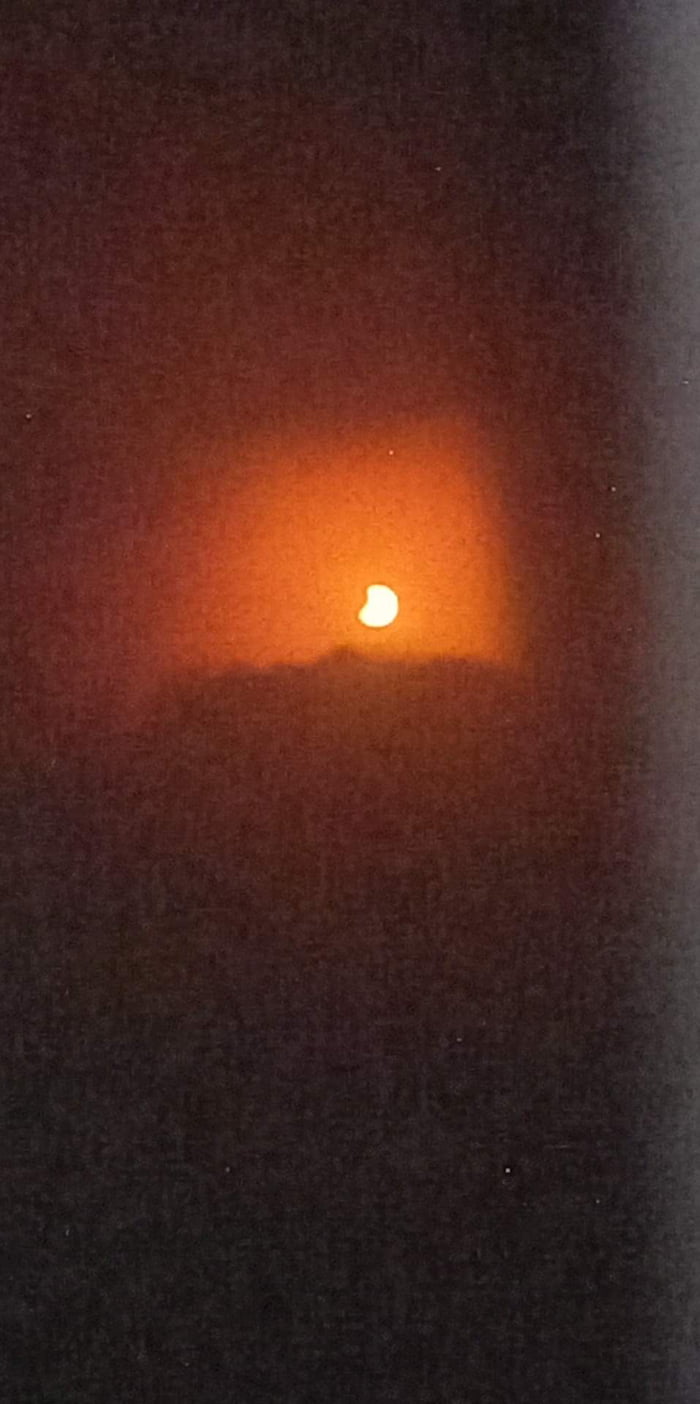Partial solar eclipse a moment ago from Belgium photographed through solar eclipse glasses - 9GAG