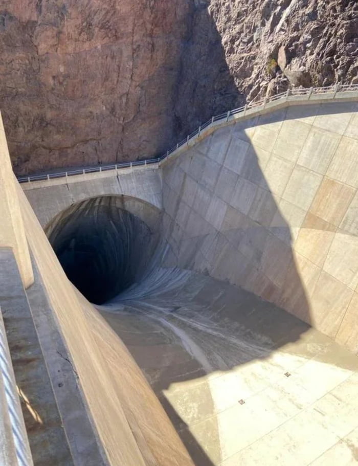 Hoover Dam spillway tunnel, 50 feet wide & 600 feet deep. You can hear rushing water down in the ...