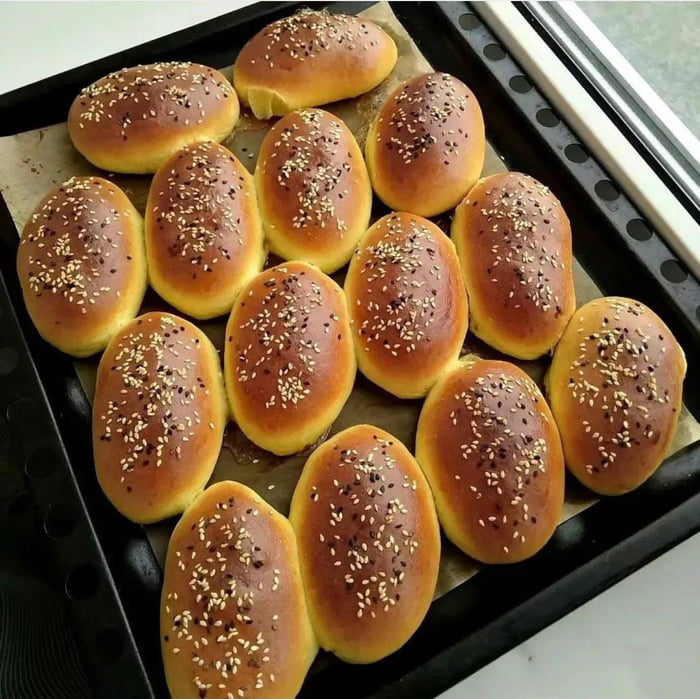 Ruddy pies with meat and cabbage sprinkled with sesame seeds and ...
