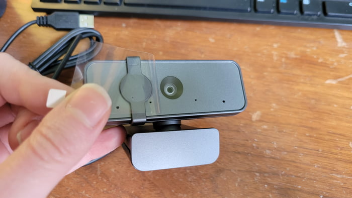 Peel-off plastic is trapped under the camera cover, which doesn't slide ...