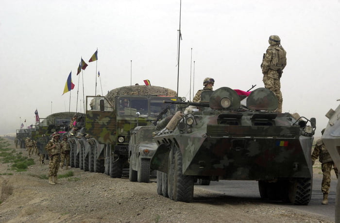 A Romanian Army TAB-77 Armored Personnel Carrier (APC) leads a convoy ...