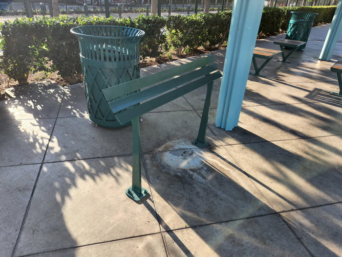 This used to be a normal bus bench. Now, it's a "leaning bench" that ...