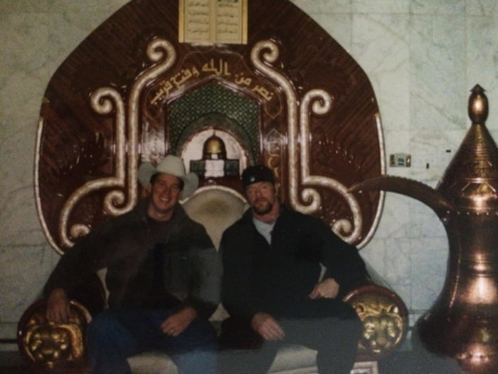 Professional wrestlers Bradshaw and The Undertaker sitting on a throne ...