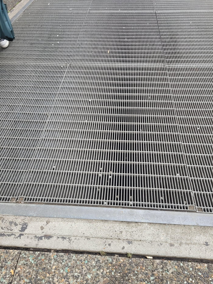 The grates on this street exactly fit a cell phone and drop them down a ...
