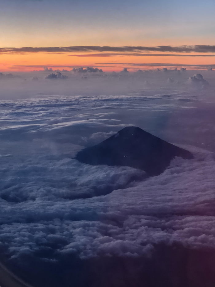 Mount Fuji peeking through a sea of clouds at sunset. Absolutely breathtaking - 9GAG