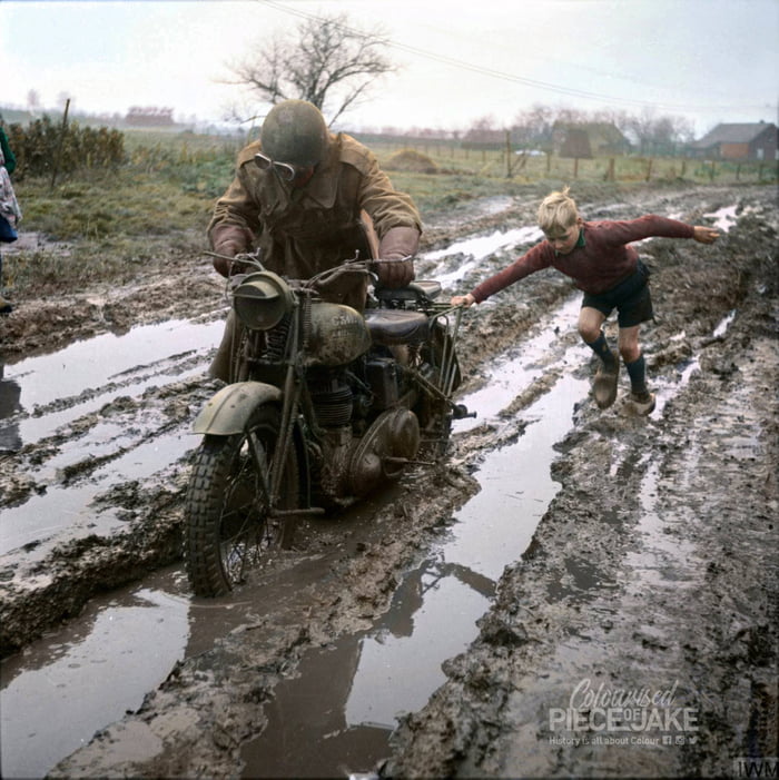 A young Dutch boy on clogs ('klompen' in Dutch) helps a Motorcycle ...