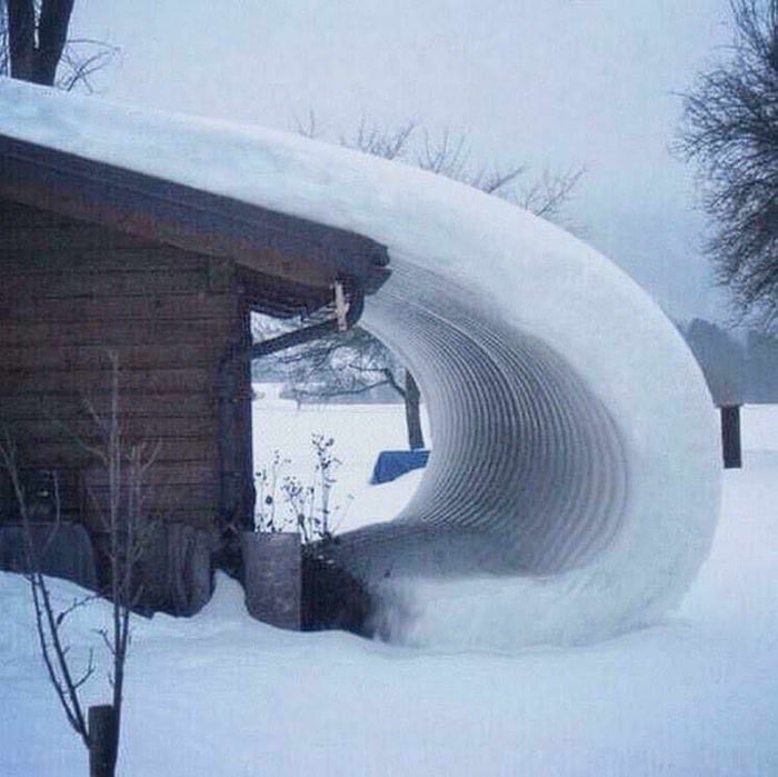 Snow curling off metal roof New Hampshire - 9GAG