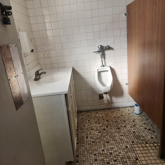 This bathroom is meant for multiple people that has 2 other toilet ...