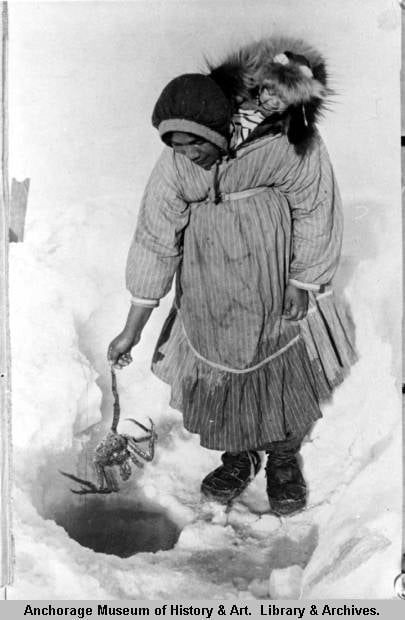 Eskimo woman and child fishing for spider crab, near Nome, Alaska ...