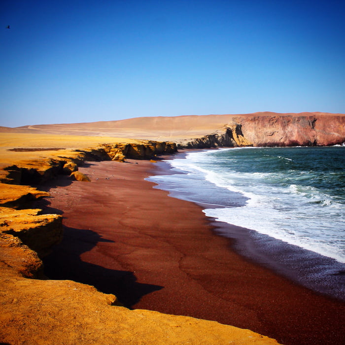 In Peru the desert meets a red sand beach that meets the ocean. - 9GAG
