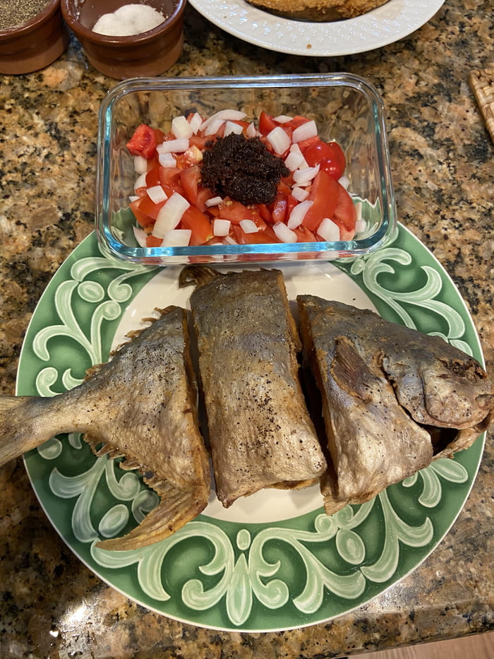 Filipino breakfast of fried Pompano fish eaten with tomatoes, onions ...