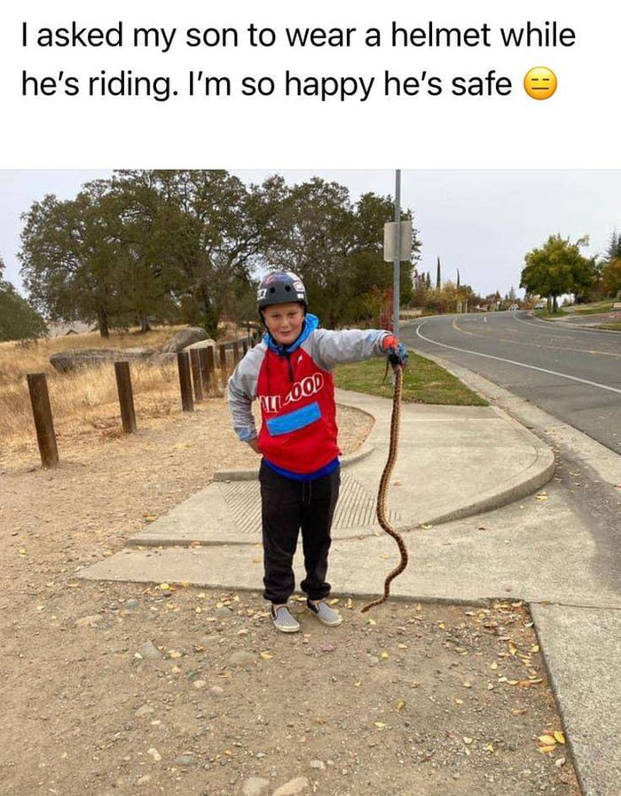 Safety first, even if it means holding a snake. - 9GAG