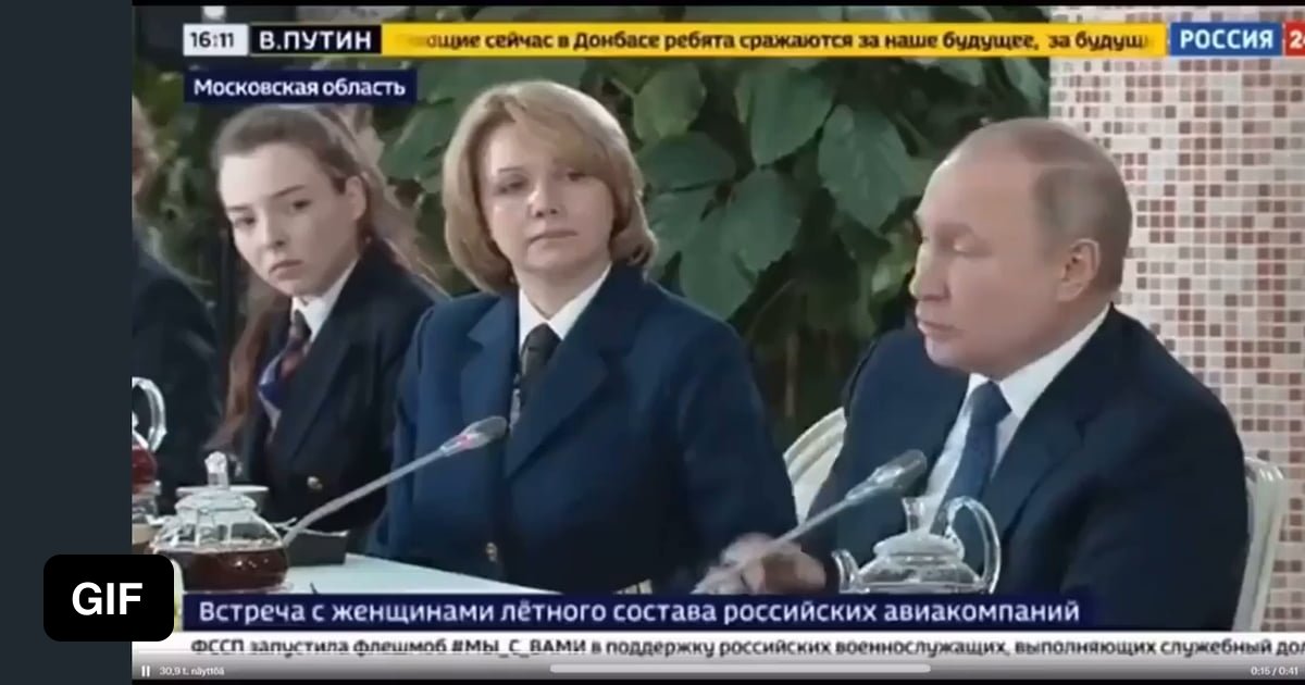 Putin’s hand appears to go through the microphone, furthering ...