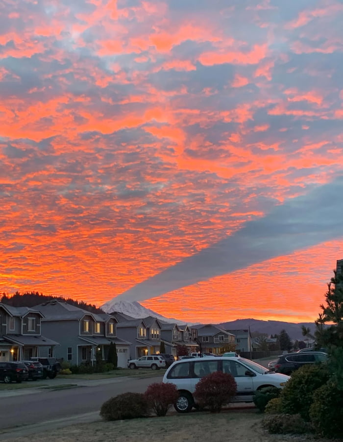 A mountain casts a perfect shadow on the clouds during sunrise — nature’s precision is mind ...
