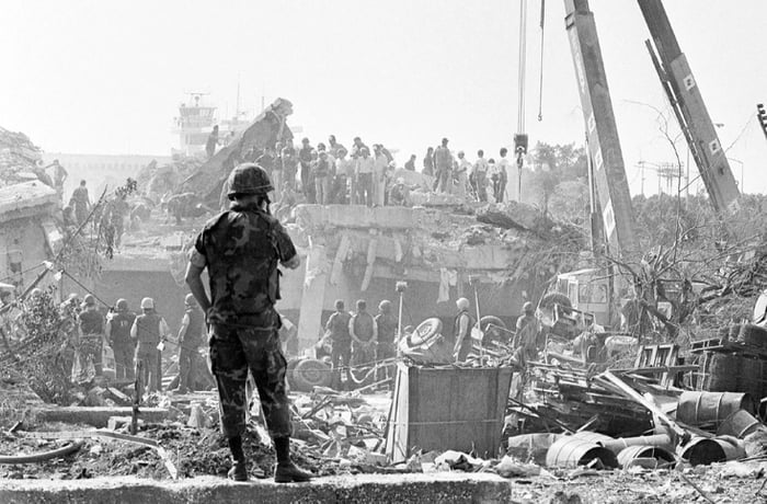 Rescuers probe the wreckage of the destroyed Battalion Landing Team ...