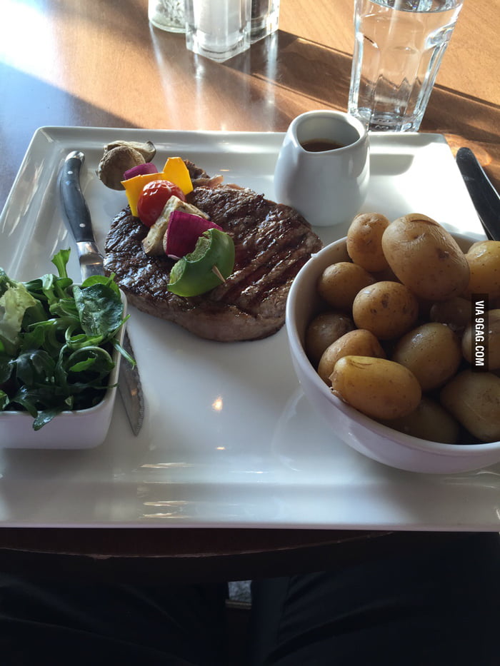 9oz Ribeye medium-rare with mint new potatoes a stick of vegetables and ...