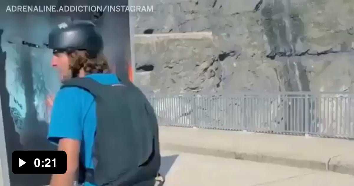 Base jumping down the face of a dam - 9GAG
