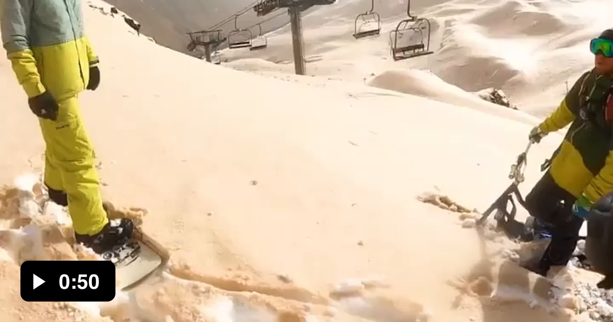 People snowboarding on snow covered in sand from the Sahara Desert ...