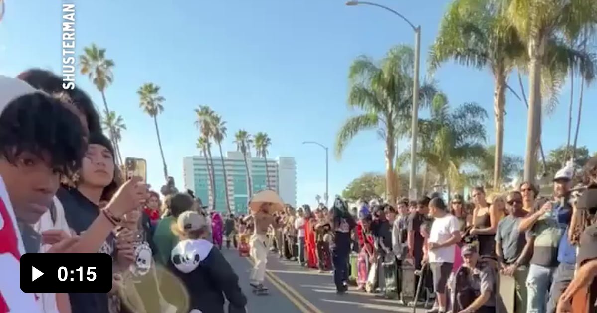 A father takes his son to a big skateboarding meet up and helps him grind a rail. The crowd ...