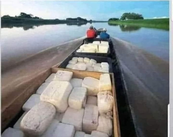 Packages of fresh cream cheese travel by boat out of a small village in ...