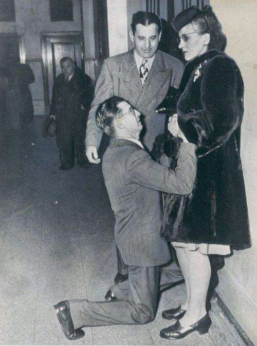 A picture from 1948 of a man begging his wife not to go on with the ...