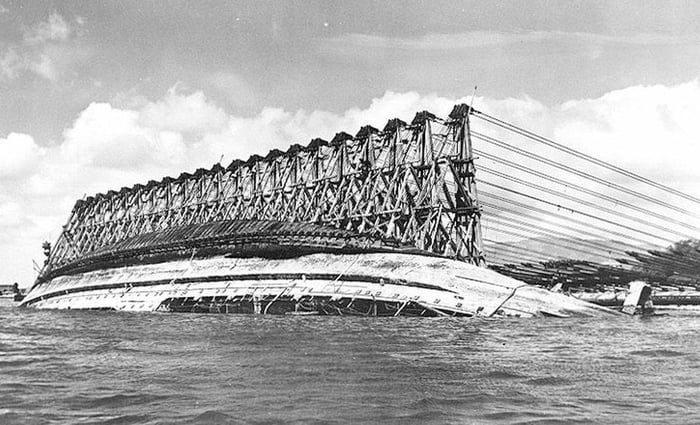 USS Oklahoma being uprighted using a salvage technique called ...