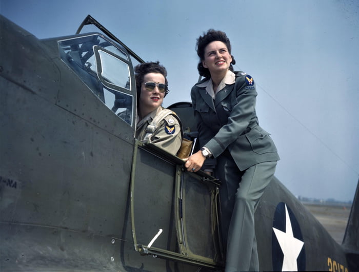 Two pilots of the Women Auxiliary Ferrying Squadron (WAFS) pose with a ...