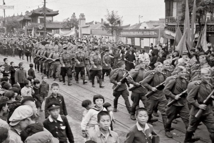 Red Army soldiers parading through a street in the northern part of the ...