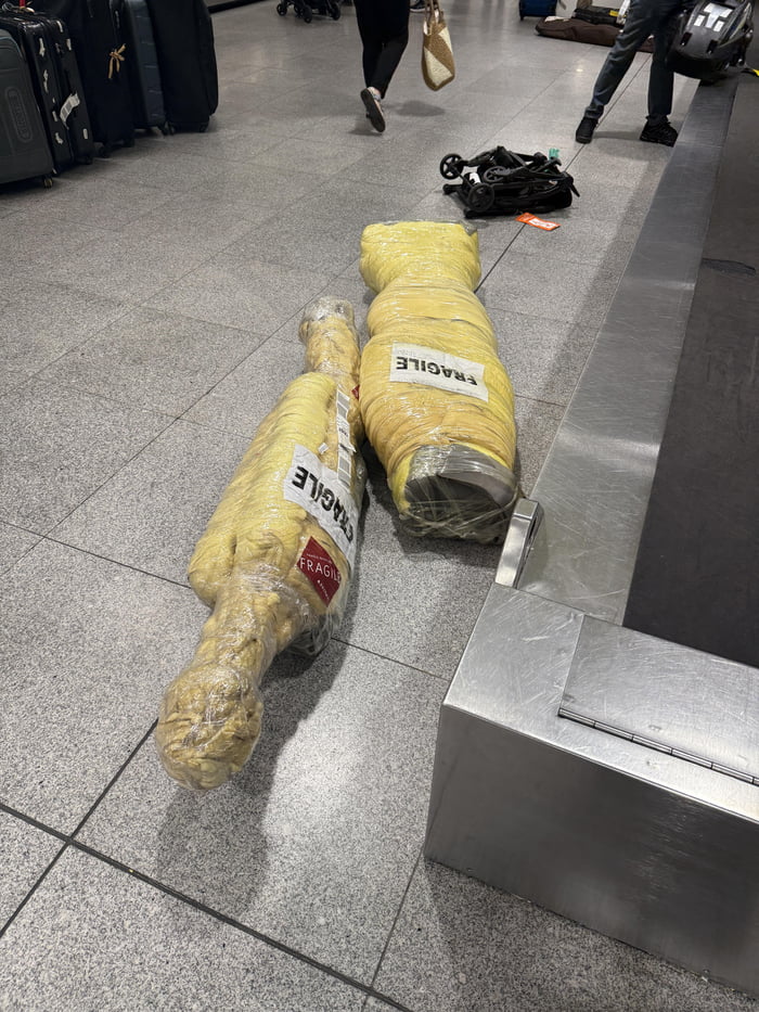 6 foot long heavy strangely wrapped fragile packages waiting in baggage ...