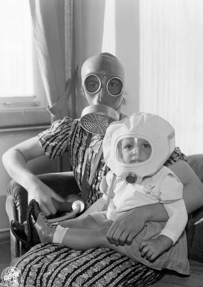 Mother and child wearing gas masks, Germany, 1937 ca. - 9GAG