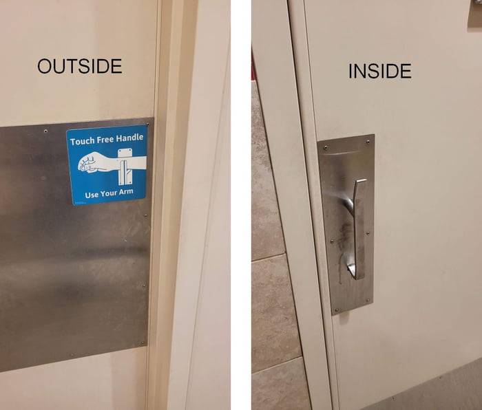 The sign showing how to use the touch free handle on this restroom door ...