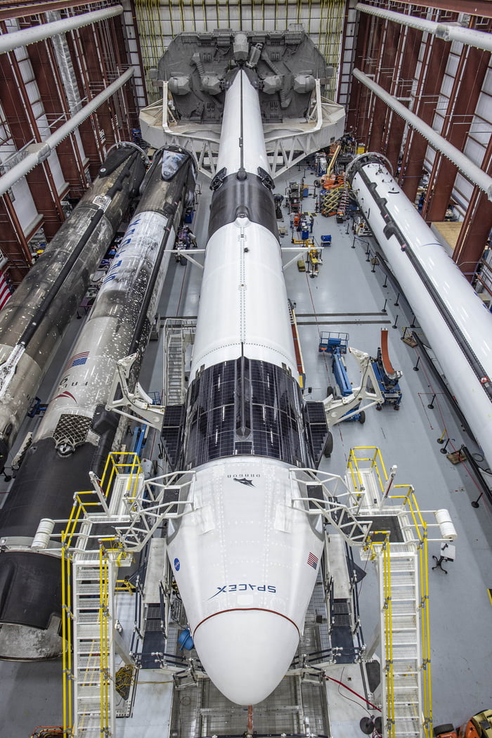 SpaceX Falcon 9 with Dragon 2 capsule sitting inside of hangar at ...