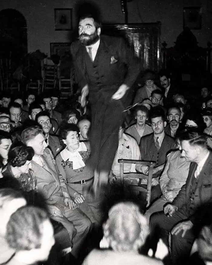 Welsh spiritualist Colin Evans feigns levitation by jumping up and down in total darkness and ...