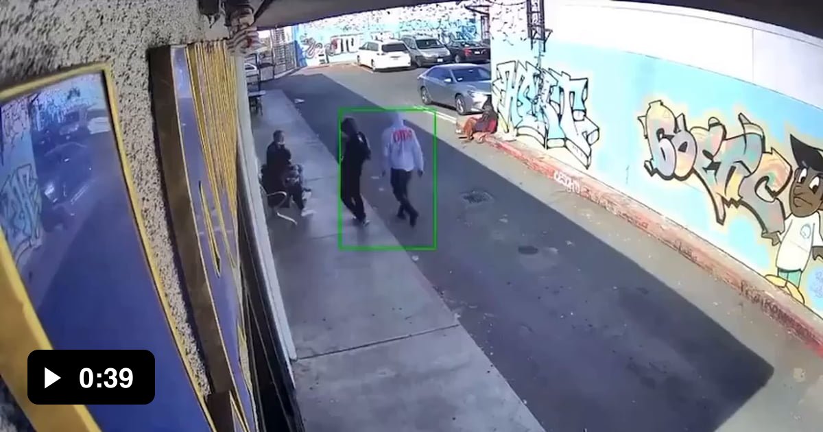 Two people getting robbed at gunpoint while sitting on a bench. - 9GAG