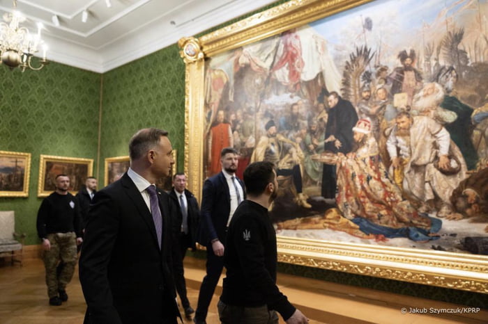 Our honored guest President Zelensky looks at a painting depicting a ...