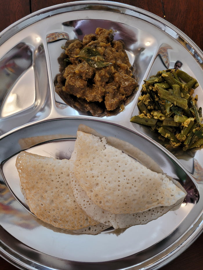 Masala beef curry with appams and guar beans made with shredded coconut ...