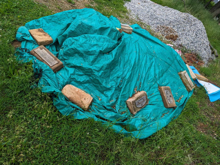 This cemetery using headstones to cover a tarp. Cemetery was purchased ...