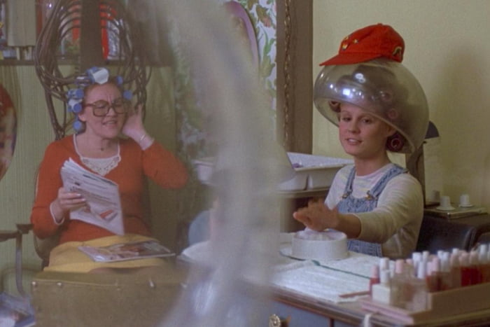 In Carrie (1976), the character of Norma wears a red baseball cap in ...