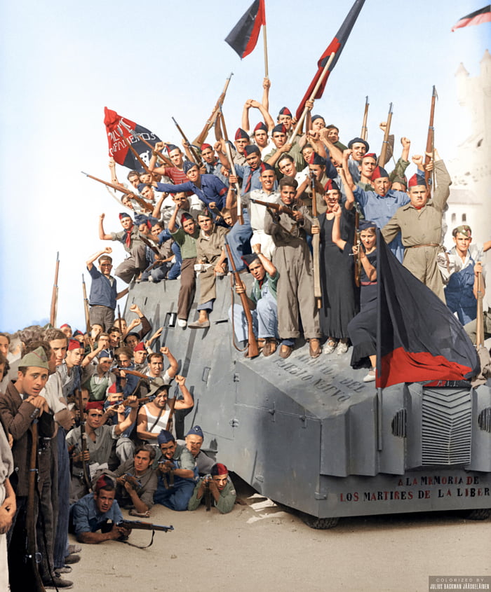 A large group of anarchist militia with a improvised armoured vehicle ...