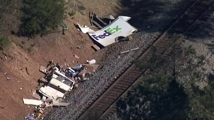 Amtrak train hits FedEx truck that ran a stop sign, killing the driver ...