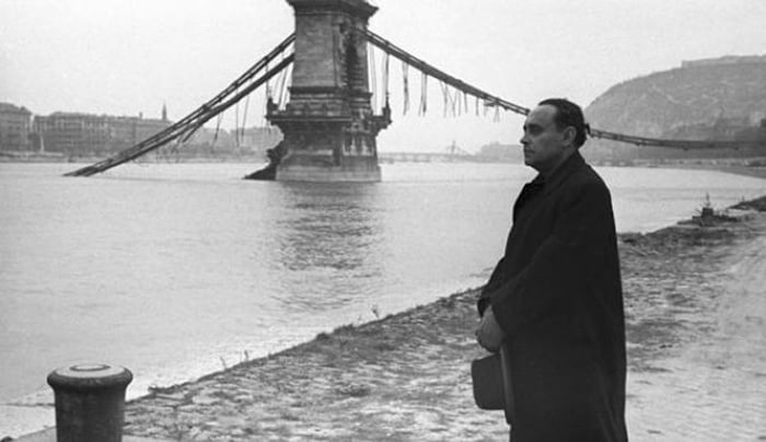 Leader of Fascist Hungary, Ferenc Szálasi, overseeing the war torn city ...