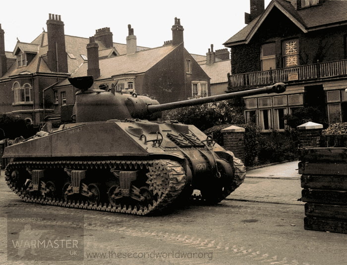 A Sherman Firefly tank, armed with a 17-pounder gun, in a residential ...