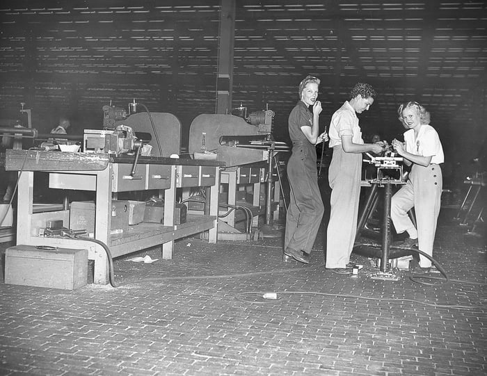 "The Ladies of Bell Bomber" - Three female employees smile for the ...