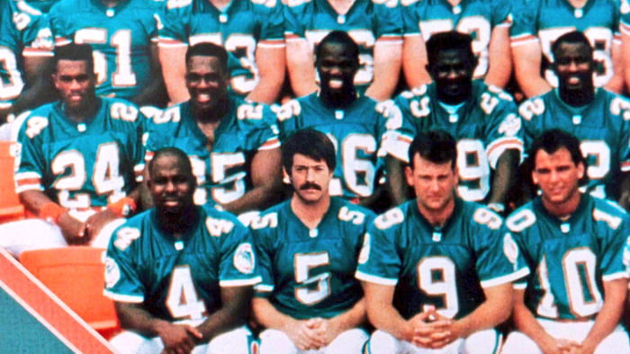 The 1984 Miami Dolphins. Kicker Ray Finkel with the moustache - 9GAG